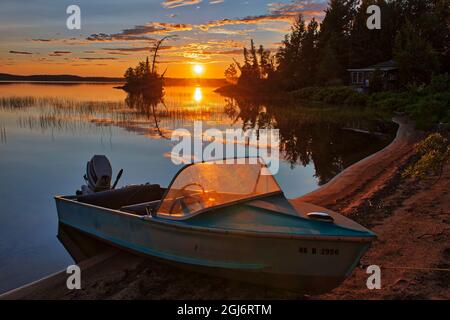 Canada, Quebec, Belleterre. Sunset on Lac des Sables and boat. Credit ...