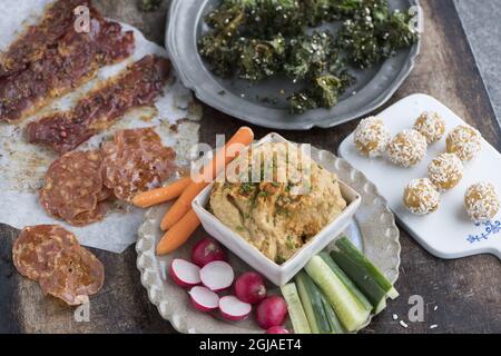 STOCKHOLM 20161103 Homemade snacks. Kale Chips, oven-dried ham, salami ...