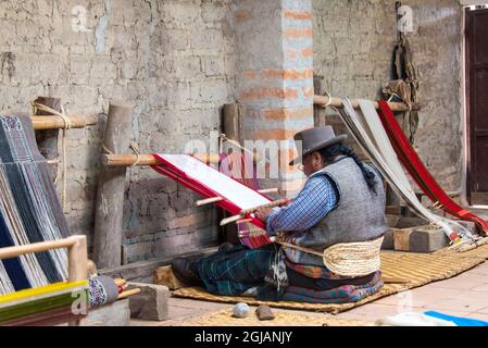 Ecuador, Otavalo. Traditional weaving workshop. All stages by hand. Man ...
