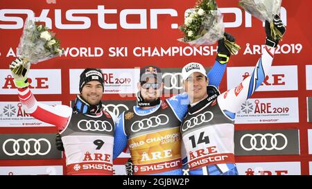 Italy's Dominik Paris, center right, celebrates on the podium with the ...