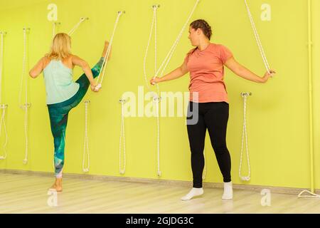 Fitness trainer and girls doing workout in the gym Stock Photo - Alamy