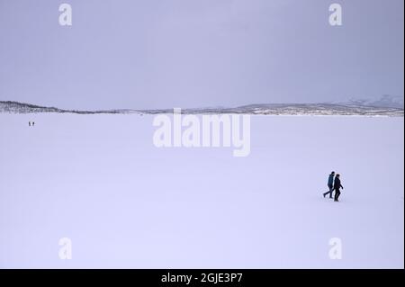 People walk on Tornetrask in Abisko National Park near STF Abisko ...