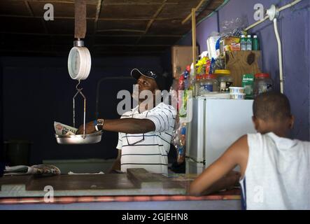 Usain Bolts father Wellesley Bolt in front of his his shop in the ...