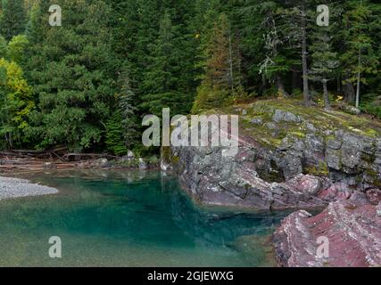 USA, Montana. Rocky outcrop, McDonald Creek, Glacier National Park ...