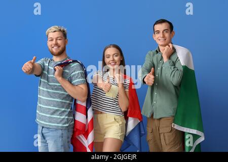 Young woman with USA flags showing something on grey background Stock ...