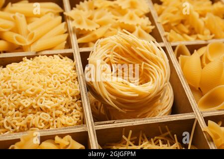 Raw pasta. Vermicelli in different colors. Pasta on a wooden background ...