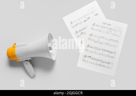 Modern megaphone and music notes on light background Stock Photo - Alamy