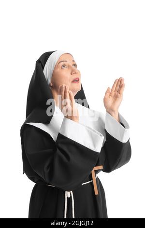 Nun praying to God on white background Stock Photo - Alamy