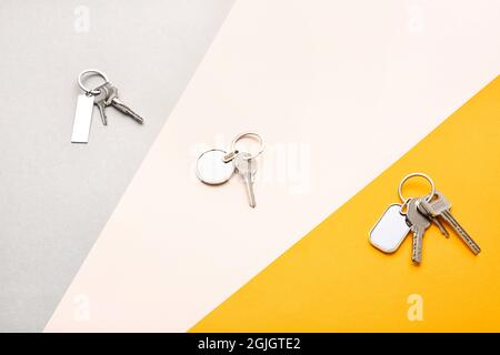 Stylish keychains on color background Stock Photo - Alamy
