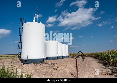 crude oil storage tanks with secondary containment and fencing in a ...