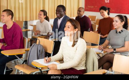 Group of different age students at extension courses in lecture room ...