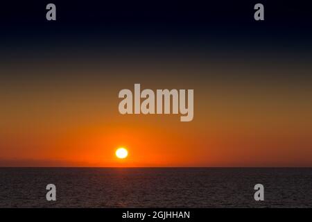 Reddish and orange colors at sunset over the Atlantic Ocean. Sun ...