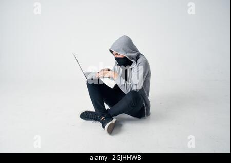 male thief stealth technique robbery safety hooligan light background ...