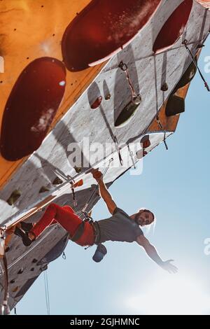 Early morning workouts. One Caucasian man professional rock climber ...