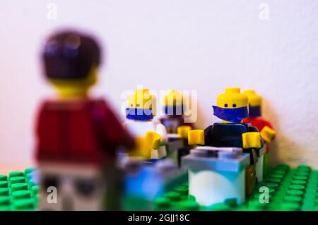 POZNAN, POLAND - May 15, 2020: Two Lego figurines wearing face masks ...