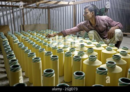 An employee during a process of yarns production before the manufacture ...