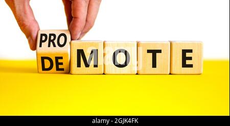 Promote or demote symbol. Businessman turns cubes and changes the word ...