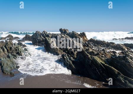 Closeup shot of sea waves beautifully touching the rocks Stock Photo ...