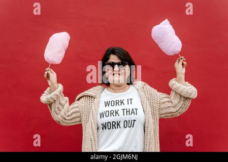 Glasses with delicious cotton candy on color background Stock Photo - Alamy