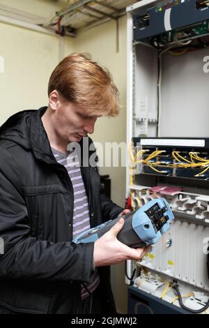 Telecom engineering technician working on a roadside mobile elevated ...