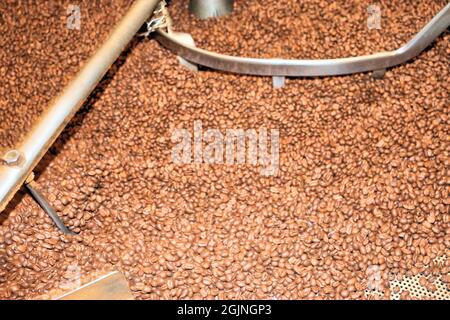 A coffee roasting factory scene with large burlap sacks filled with ...