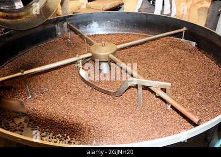 A coffee roasting factory scene with large burlap sacks filled with ...