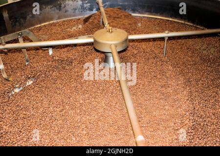 A coffee roasting factory scene with large burlap sacks filled with ...