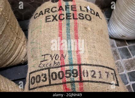 A coffee roasting factory scene with large burlap sacks filled with ...