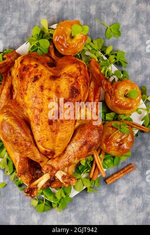 Grilled turkey garnished with caramel apples and clover leaves Stock ...