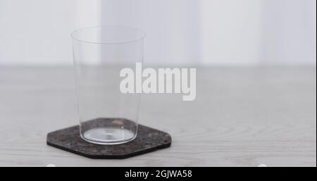 Empty tumbler glass on oak table, 120fps Stock Photo - Alamy