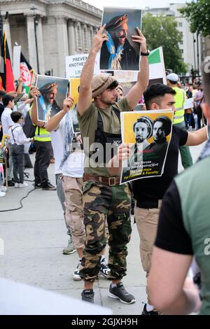 12th Sept, 2021. London, UK. A masked demonstrator holds a Palestinian ...
