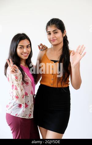 Two Indian best friends happily posing on a white background Stock ...