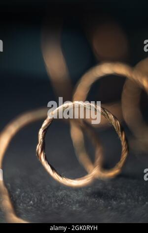 Closeup shot of a twisted copper wire on a wooden fence with blurred ...