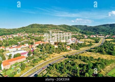 Village near mountain and agricultural fields at sunset. Nature ...