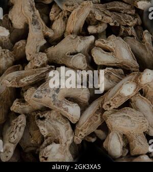 Finely dry Ginger powder in bowl with green leaves isolated on colored ...