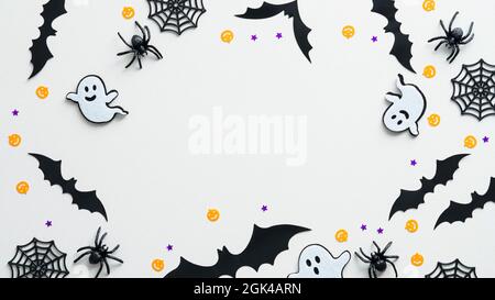 Happy Halloween! Black ghosts and spiders flat lay on orange background ...