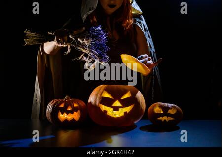 The evil witch casts a spell on pumpkins. Portrait of a woman in a ...