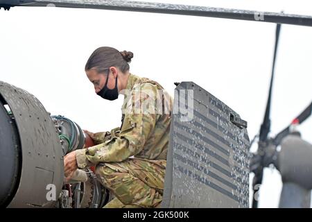Warrant Officer Stephanie Sills inspects a UH-60M Black Hawk helicopter ...