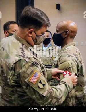 Lt. Gen. Bill Burleson (left), Eighth Army commanding general, places ...