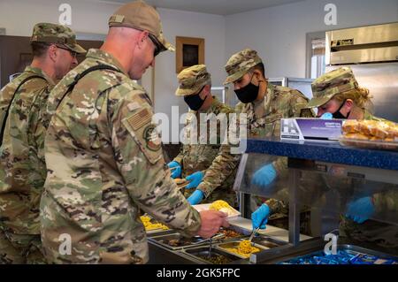 Col. Shariful Khan, left, the 310th Space Wing commander gives a ...