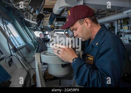 US Navy Lt. Cmdr. looks over the fly deck aboard Nimitz-class aircraft ...