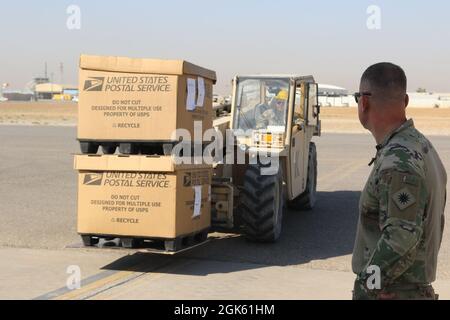Cargo is loaded onto a CH-47 Chinook helicopter prior to a flight at ...