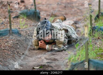 A Soldier crawls under an obstacle during the Florida Army National ...