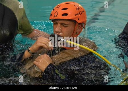 A Marine emerges from the water during a training exercise at Camp ...