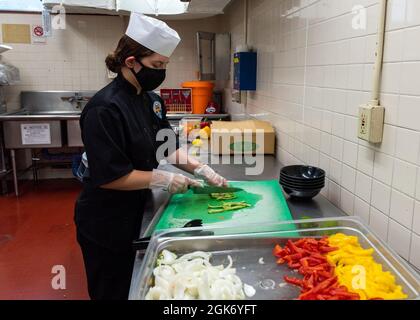 A Marine attached to Marine Corps Air Facility (MCAF) presents flowers ...