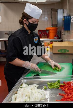 A Marine attached to Marine Corps Air Facility (MCAF) presents flowers ...