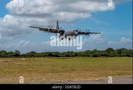 A C-130 Hercules cargo aircraft kicks up debris as it takes off from ...