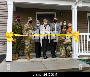 Sgt. Damian McGregor, his wife Rebekka, and their children help cut the ...
