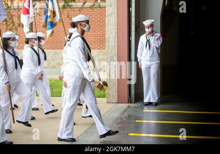 Sailors graduating from boot camp stand in formation after entering ...