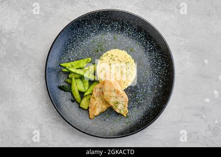 Fried zander fillet in breading with mashed potatoe and pickled ...